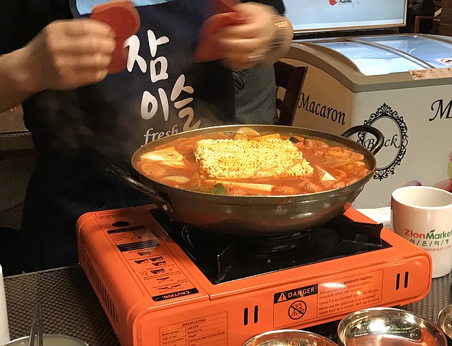 A feast of Army Base Stew, kimchi, ramen and Spam at Friend’s House in ...